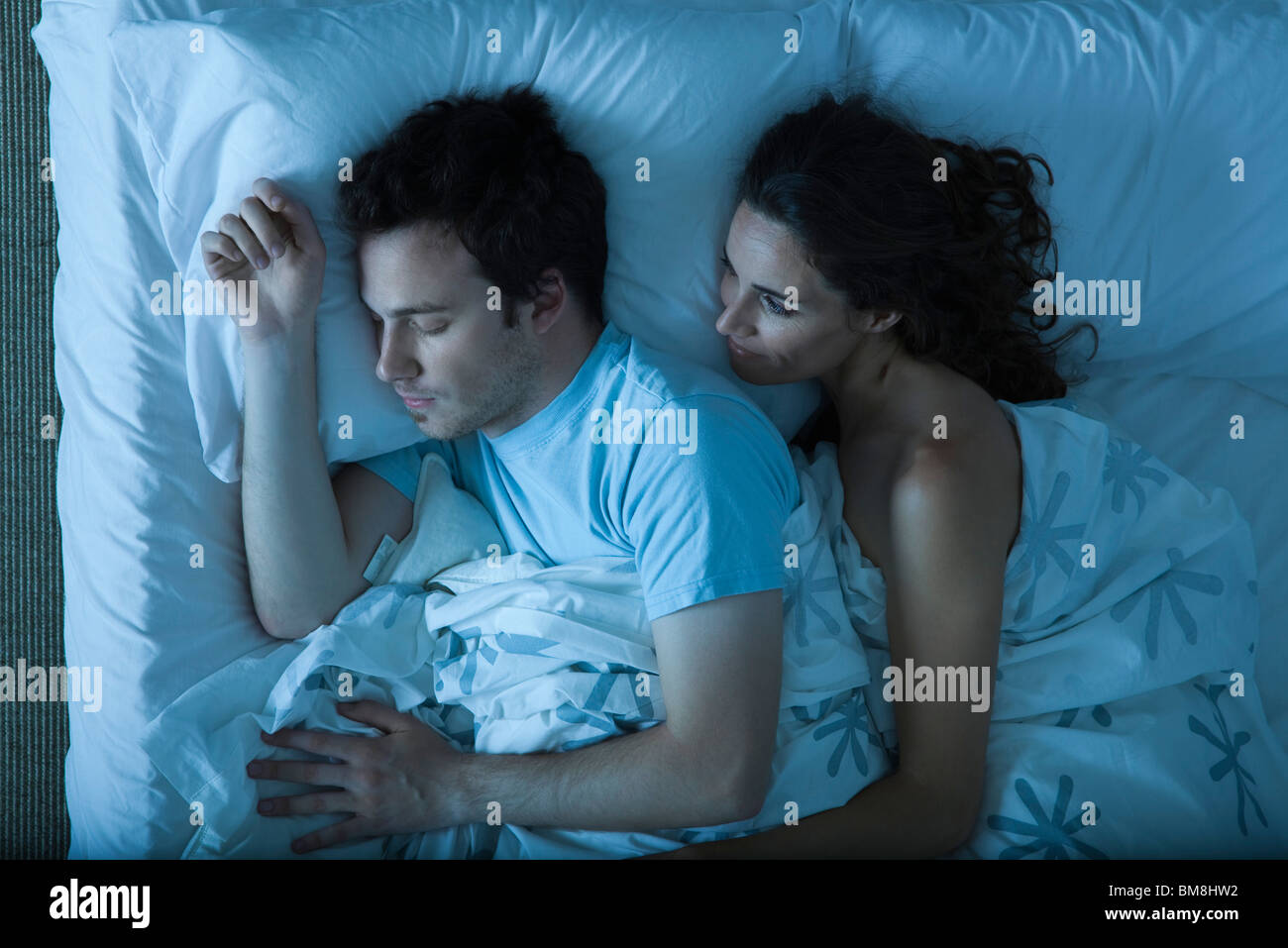 Couple spooning in bed hi-res stock photography and images - Alamy