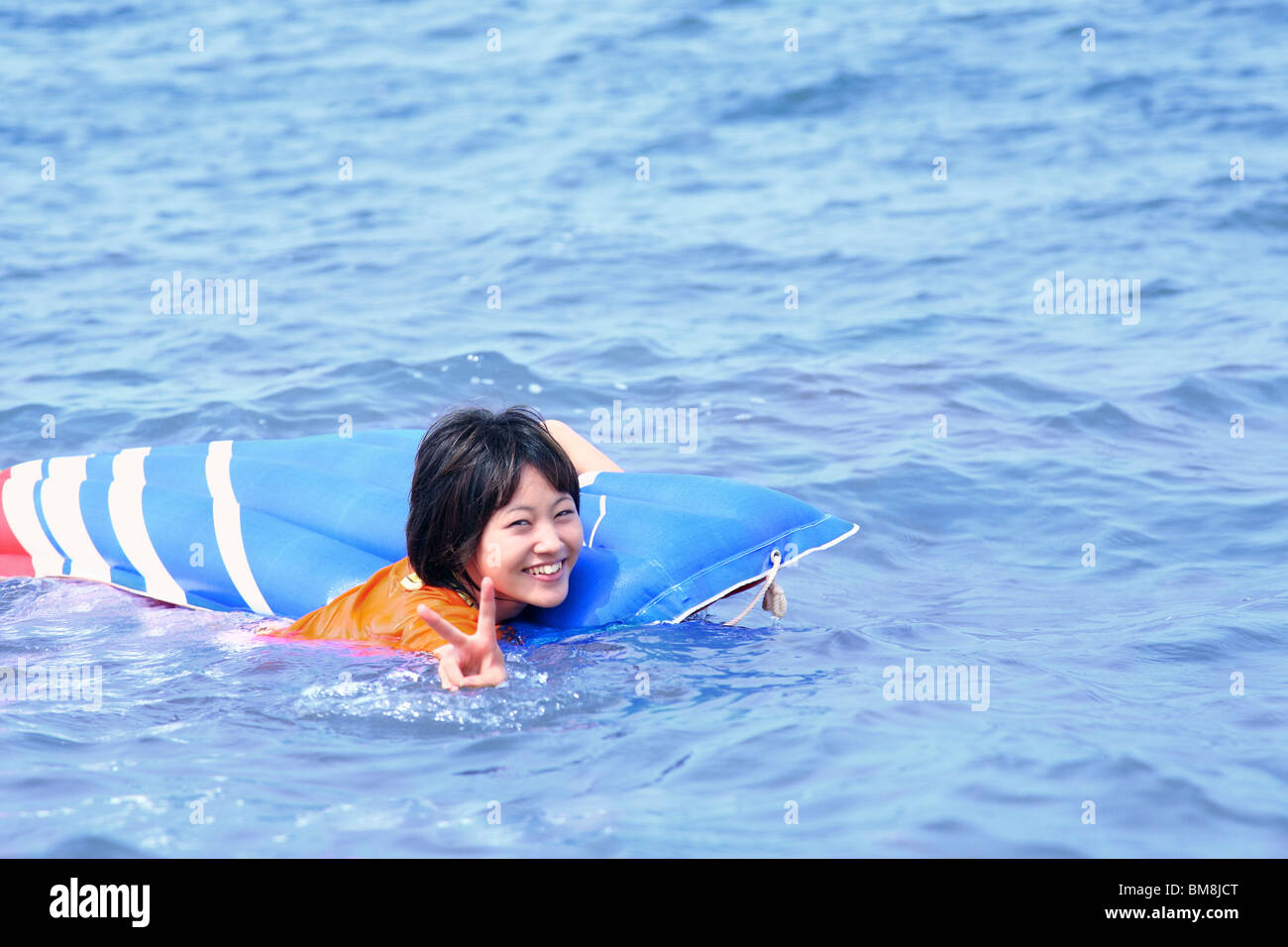 Young woman swimming at sea, Toyama Prefecture, Honshu, Japan Stock ...
