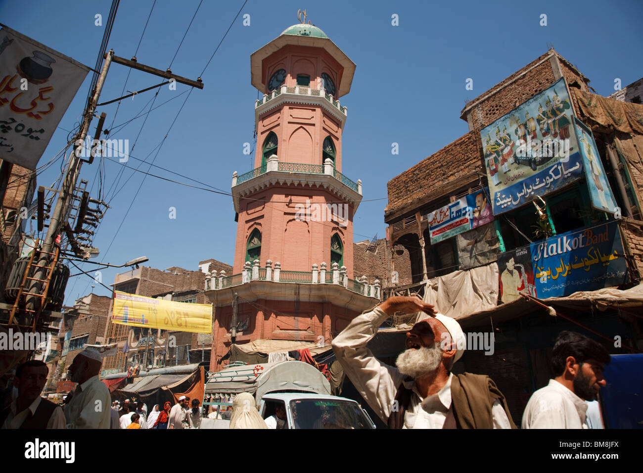A street scene (daily life) with people and a mosque in Peshawar ...