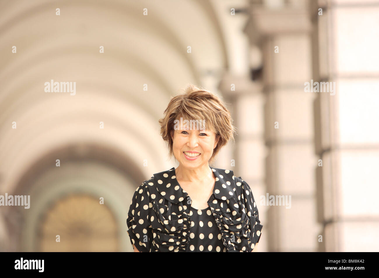 Woman standing in arcade hi-res stock photography and images - Alamy