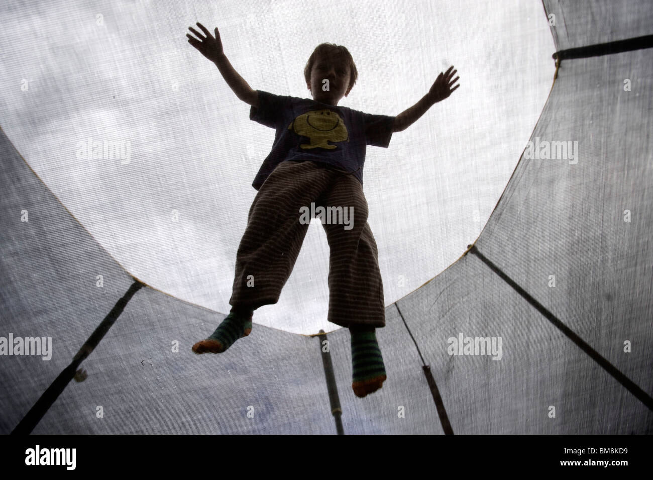 4 year old boy leaping for joy on a trampoline Stock Photo - Alamy