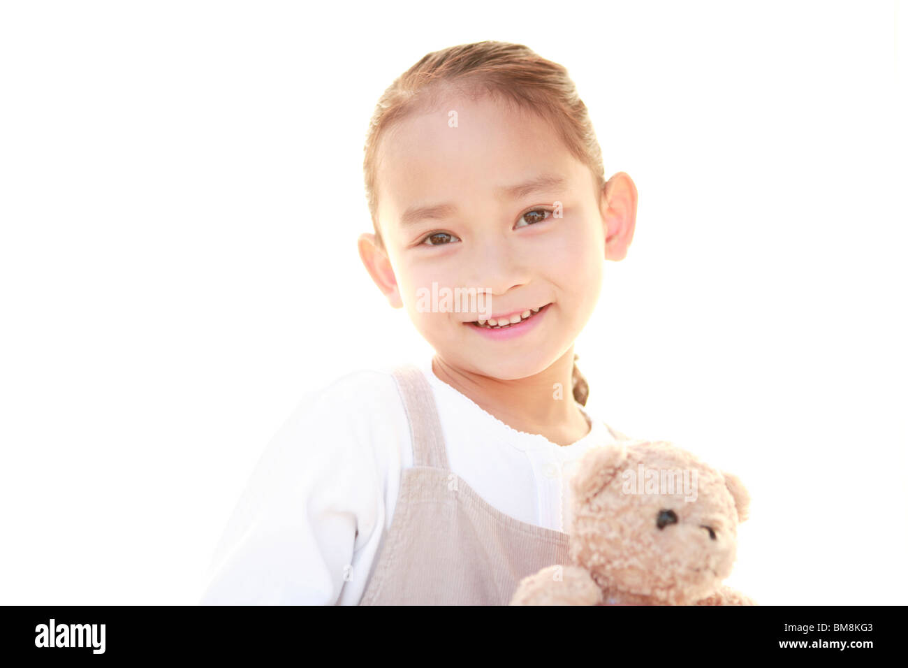 Portrait of a girl holding stuffed animal Stock Photo - Alamy