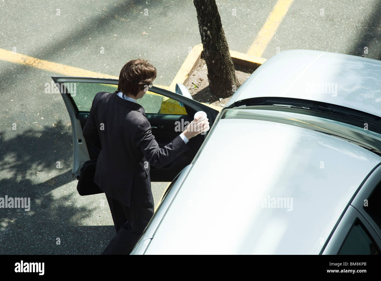 Businessman getting into car Stock Photo - Alamy Businessman getting into car Stock Photo - Alamy