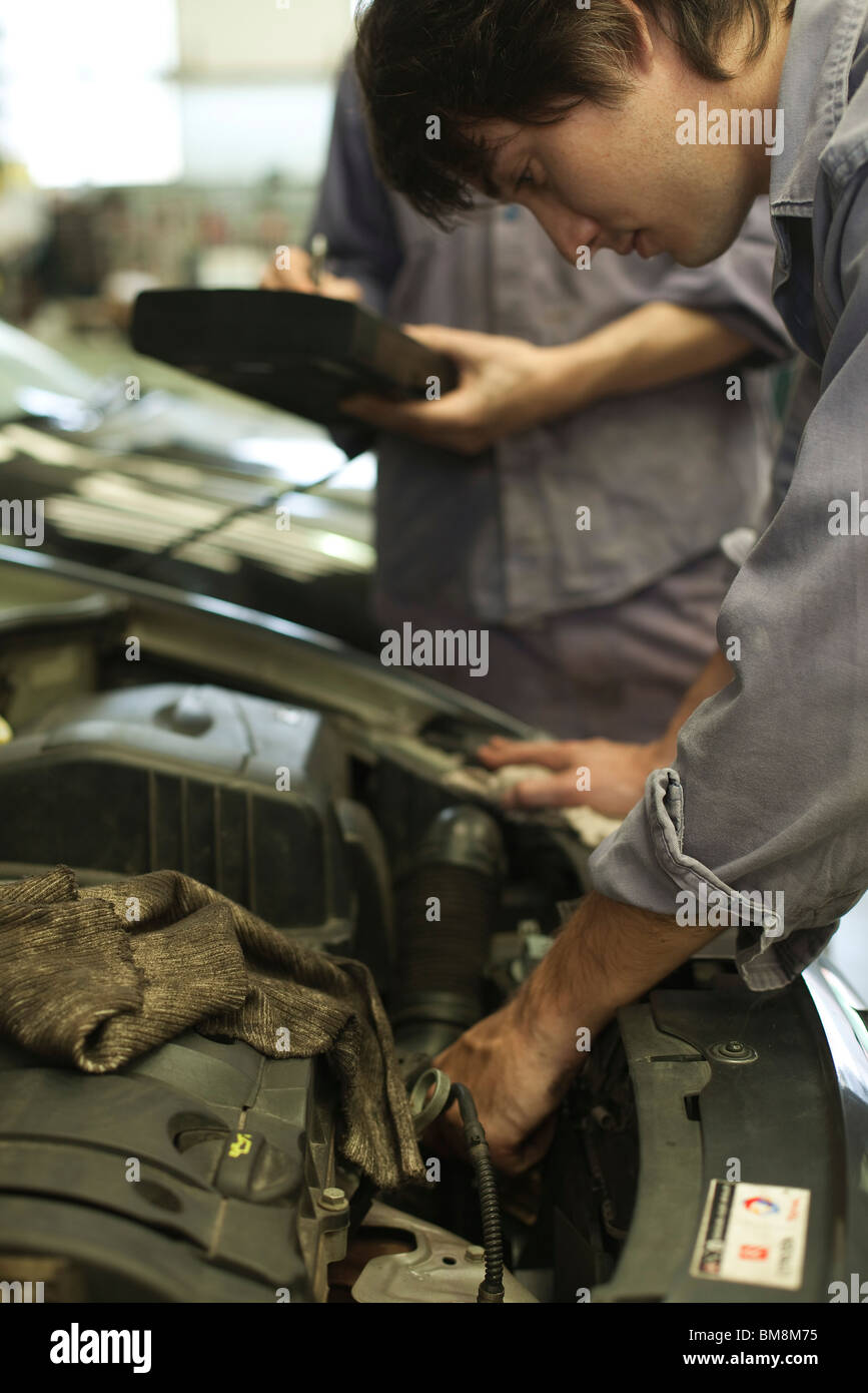 Mechanics repairing car engine Stock Photo - Alamy