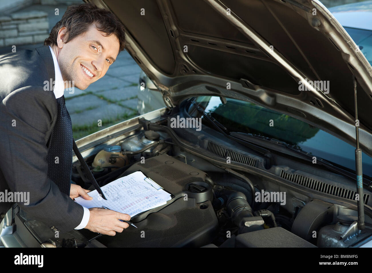 Inspecting car engine Stock Photo - Alamy
