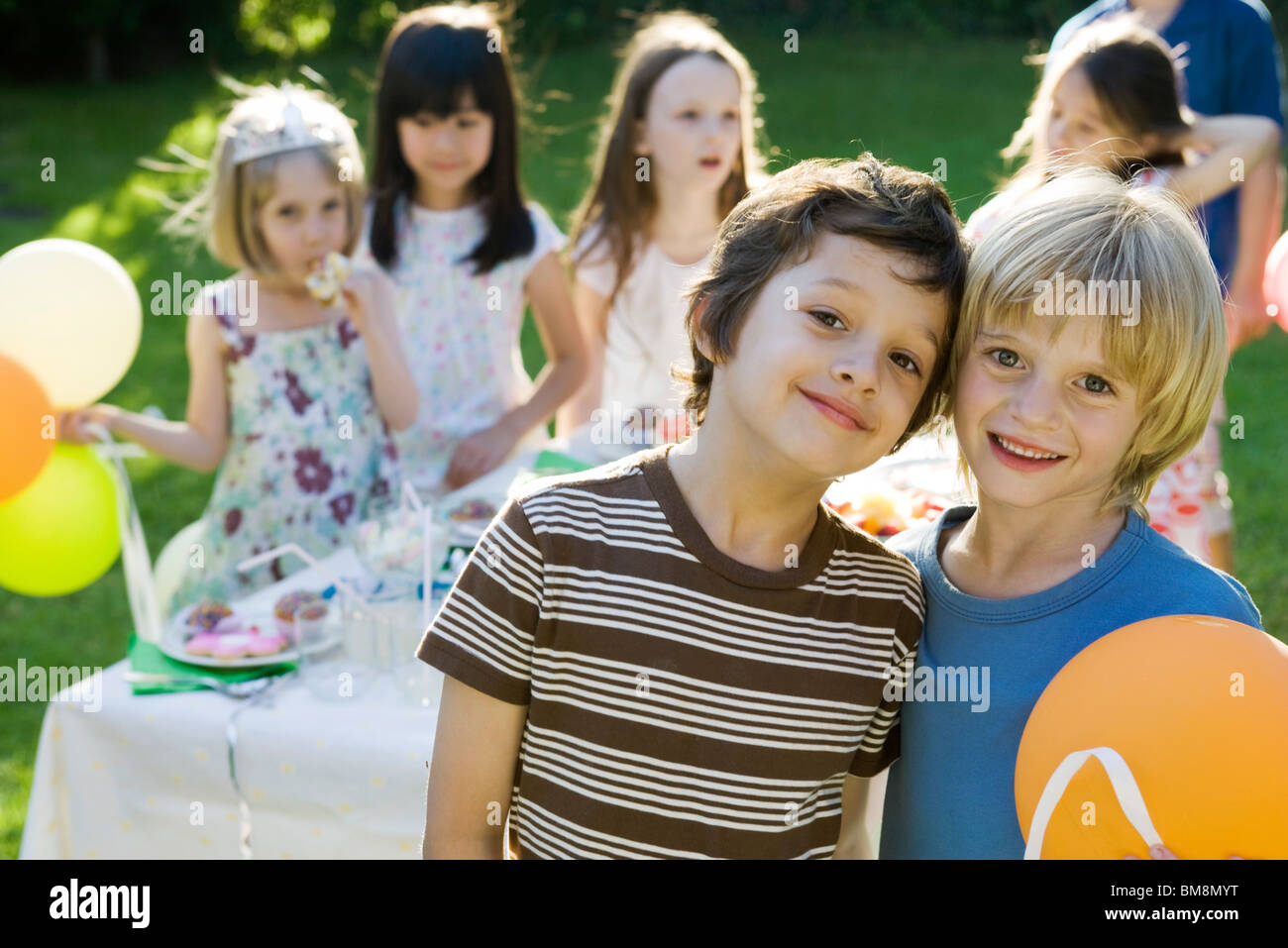 Young friends together at outdoor birthday party, portrait Stock Photo ...