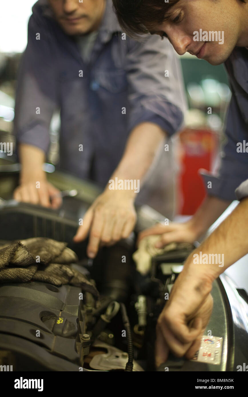 Mechanics repairing car engine Stock Photo - Alamy