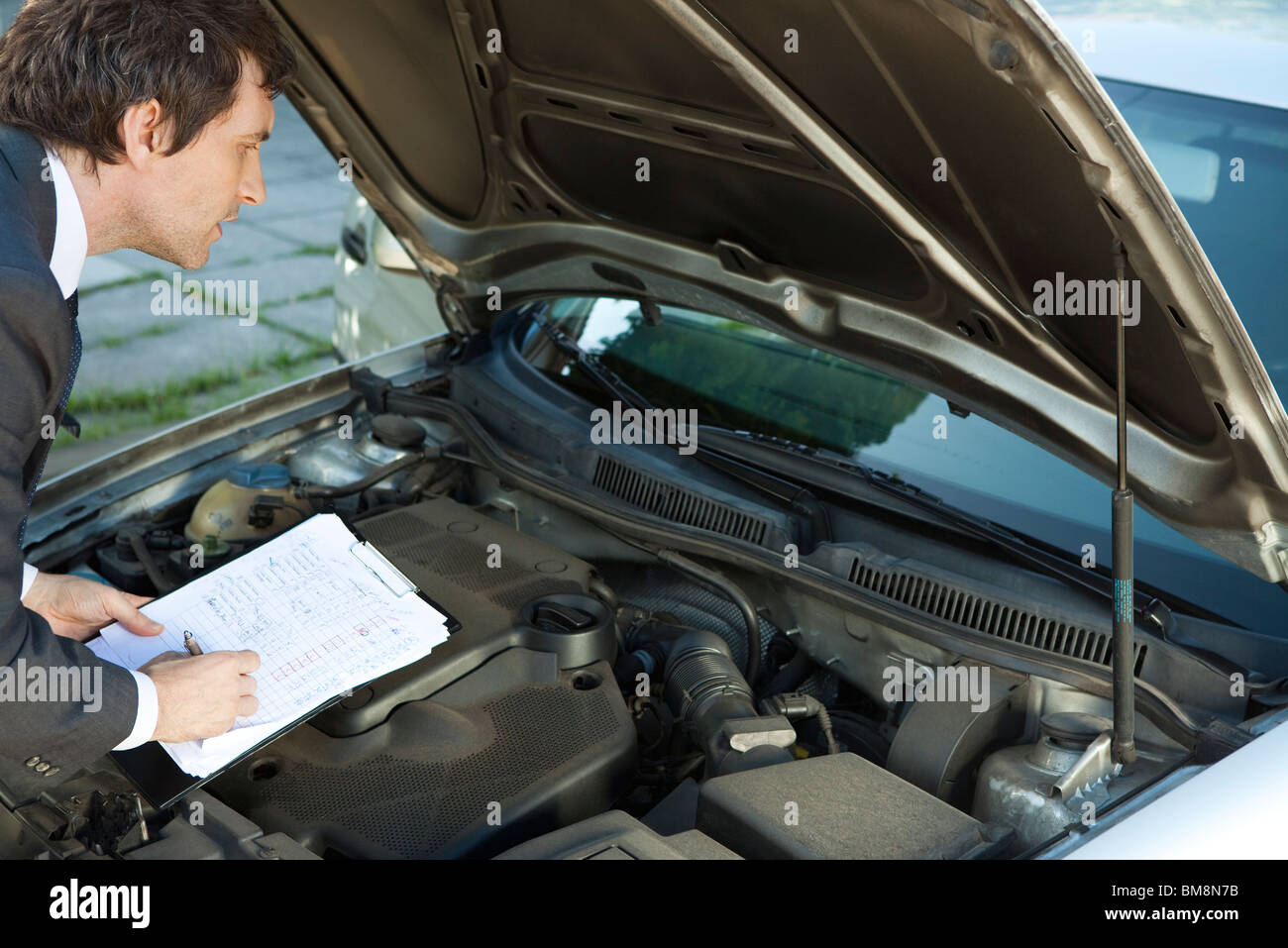 Inspecting car engine Stock Photo - Alamy