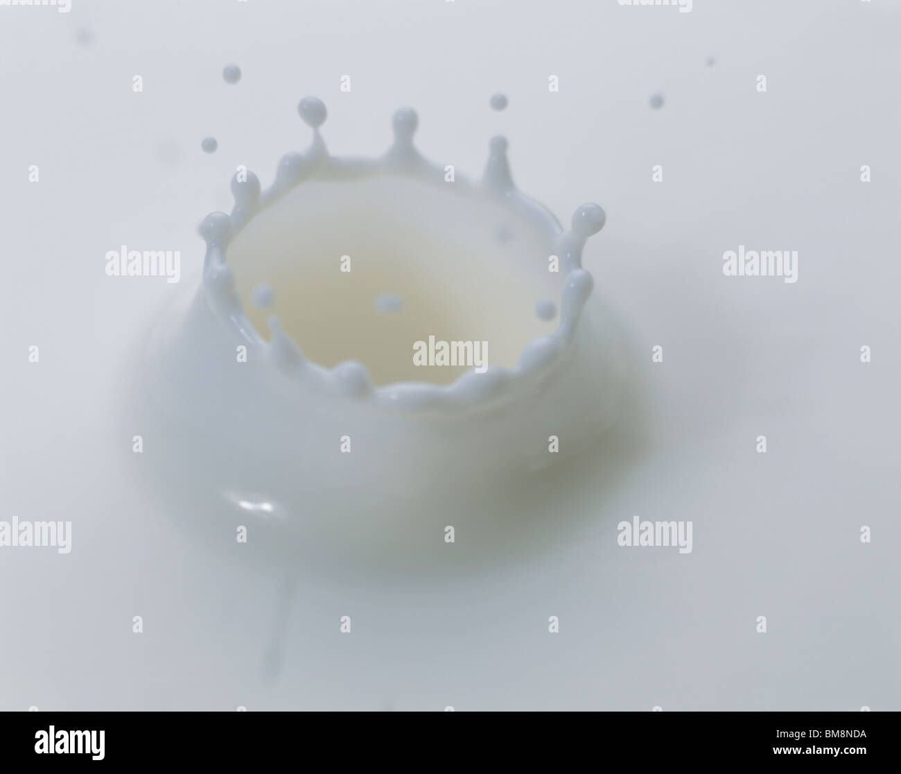 Drop of milk splashing Stock Photo - Alamy
