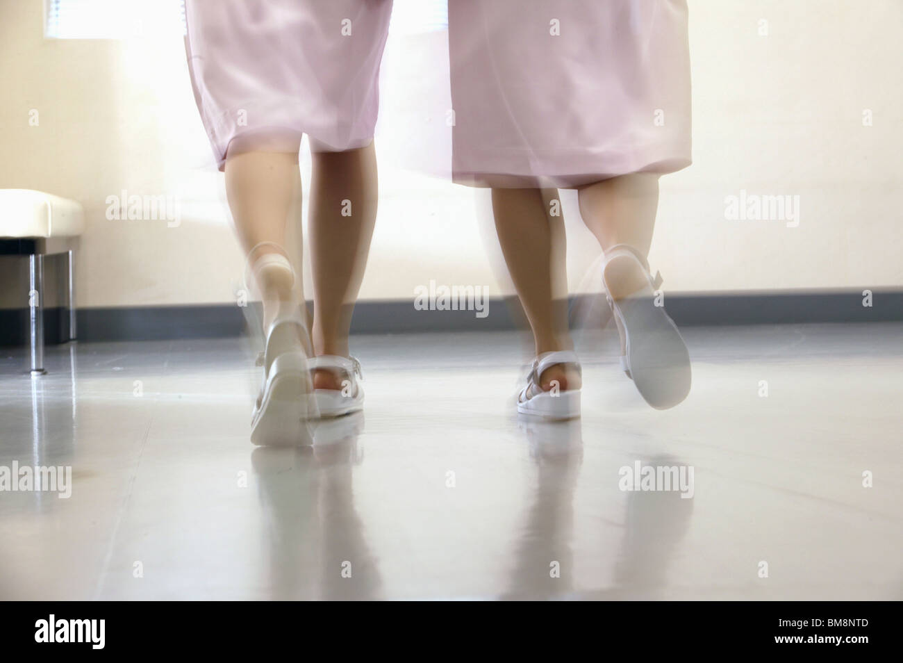 Female nurses walking in corridor quickly, blurred motion Stock Photo ...