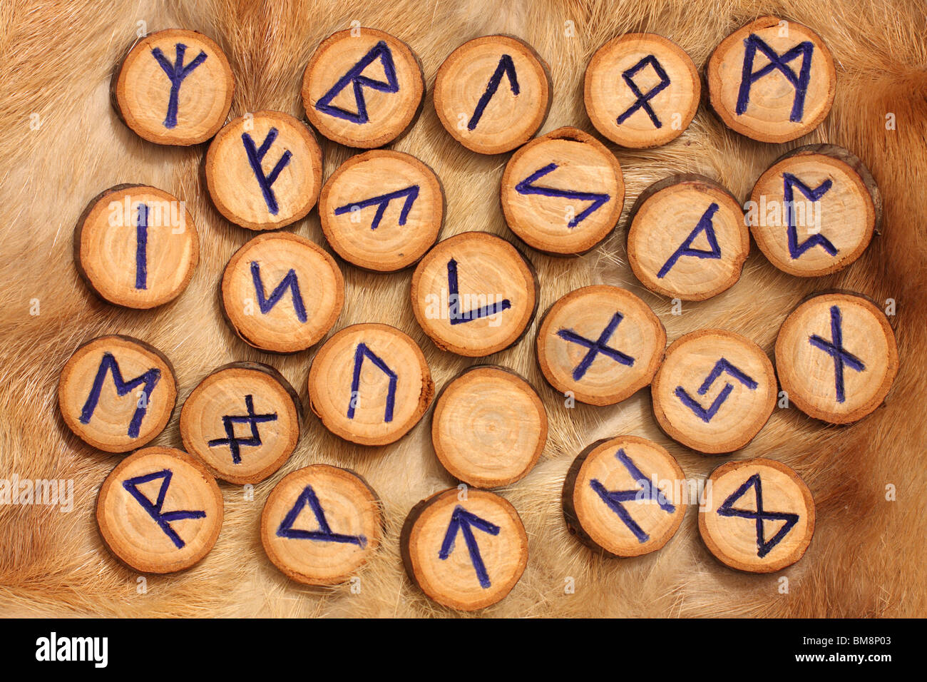 Handmade wooden runes on the fur Stock Photo - Alamy