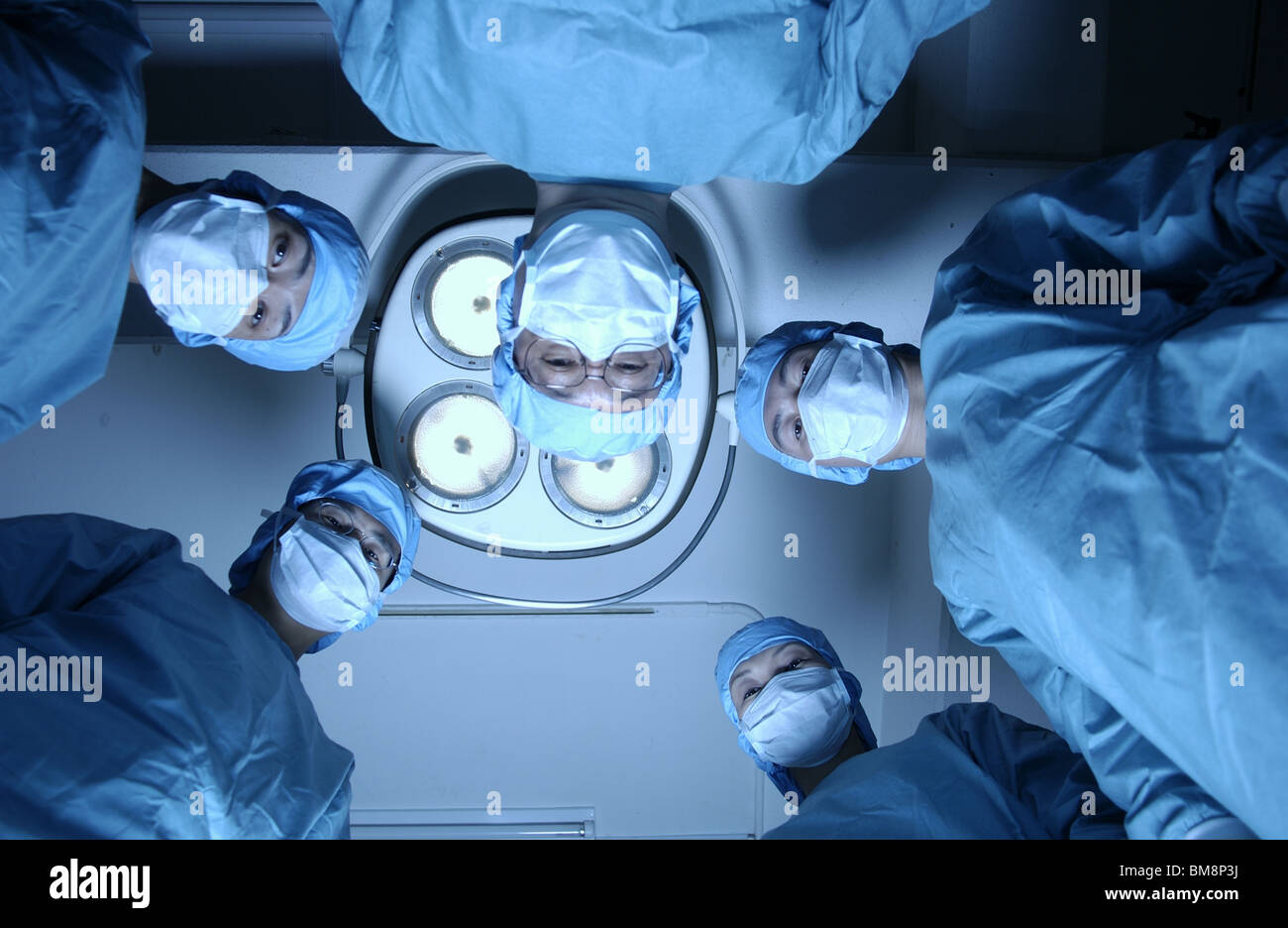 Five surgeons from operating table Stock Photo - Alamy