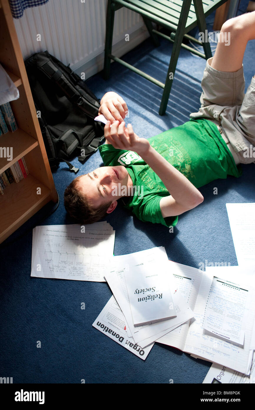 teenage boy revising for GCSE examinations in bedroom Stock Photo - Alamy