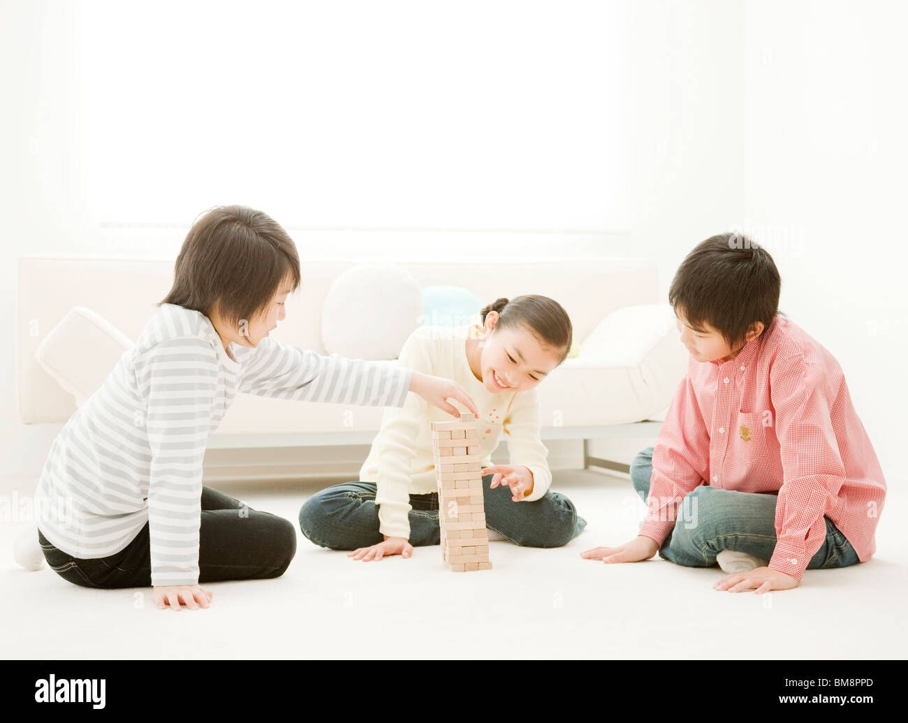 Friends playing Jenga Stock Photo - Alamy