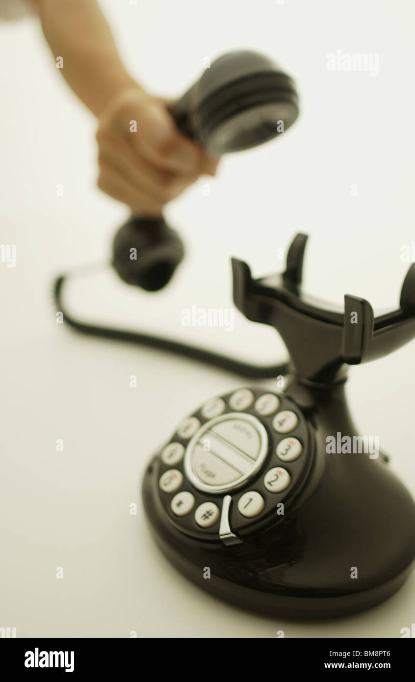Hand holding telephone receiver white background Stock Photo - Alamy