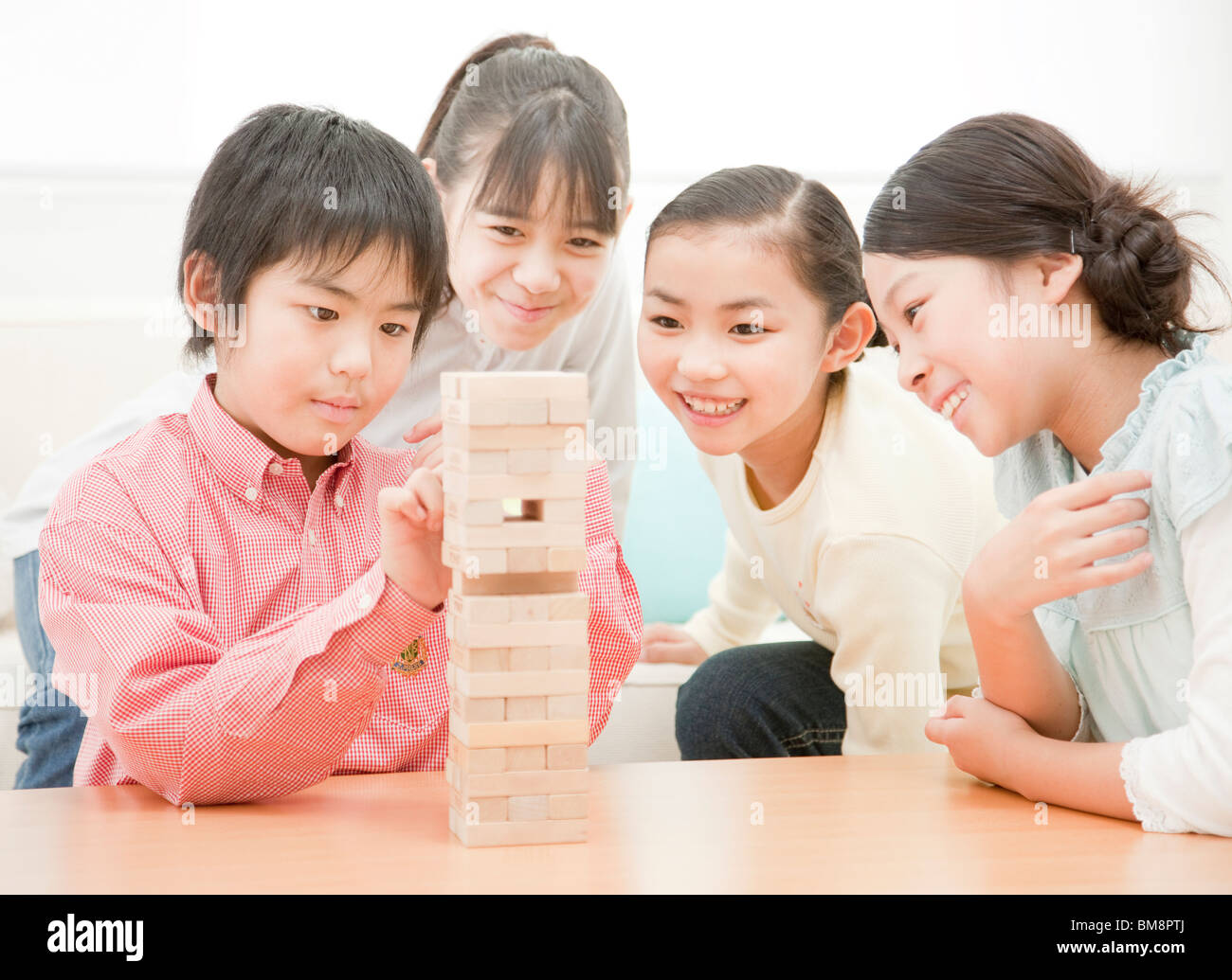 Friends playing Jenga Stock Photo - Alamy