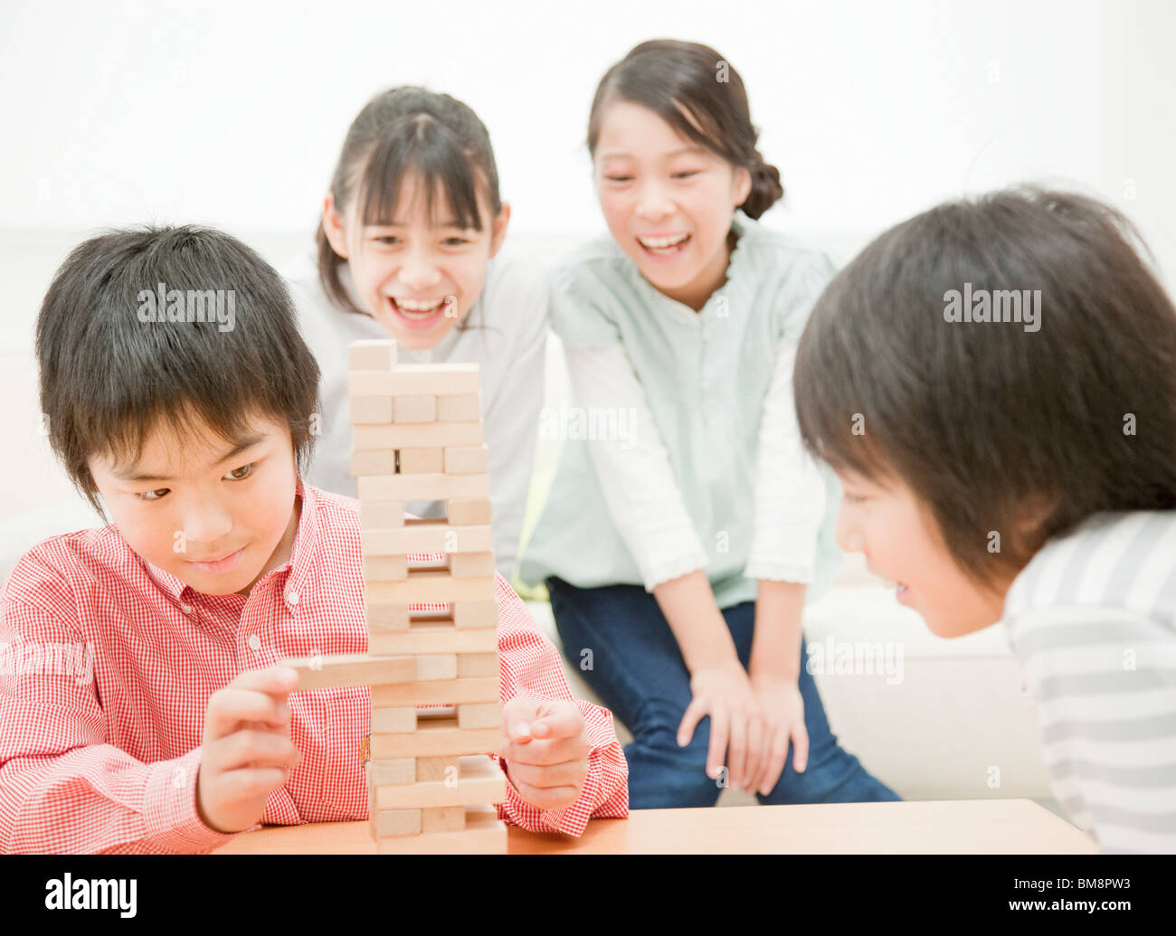 Friends playing Jenga Stock Photo - Alamy