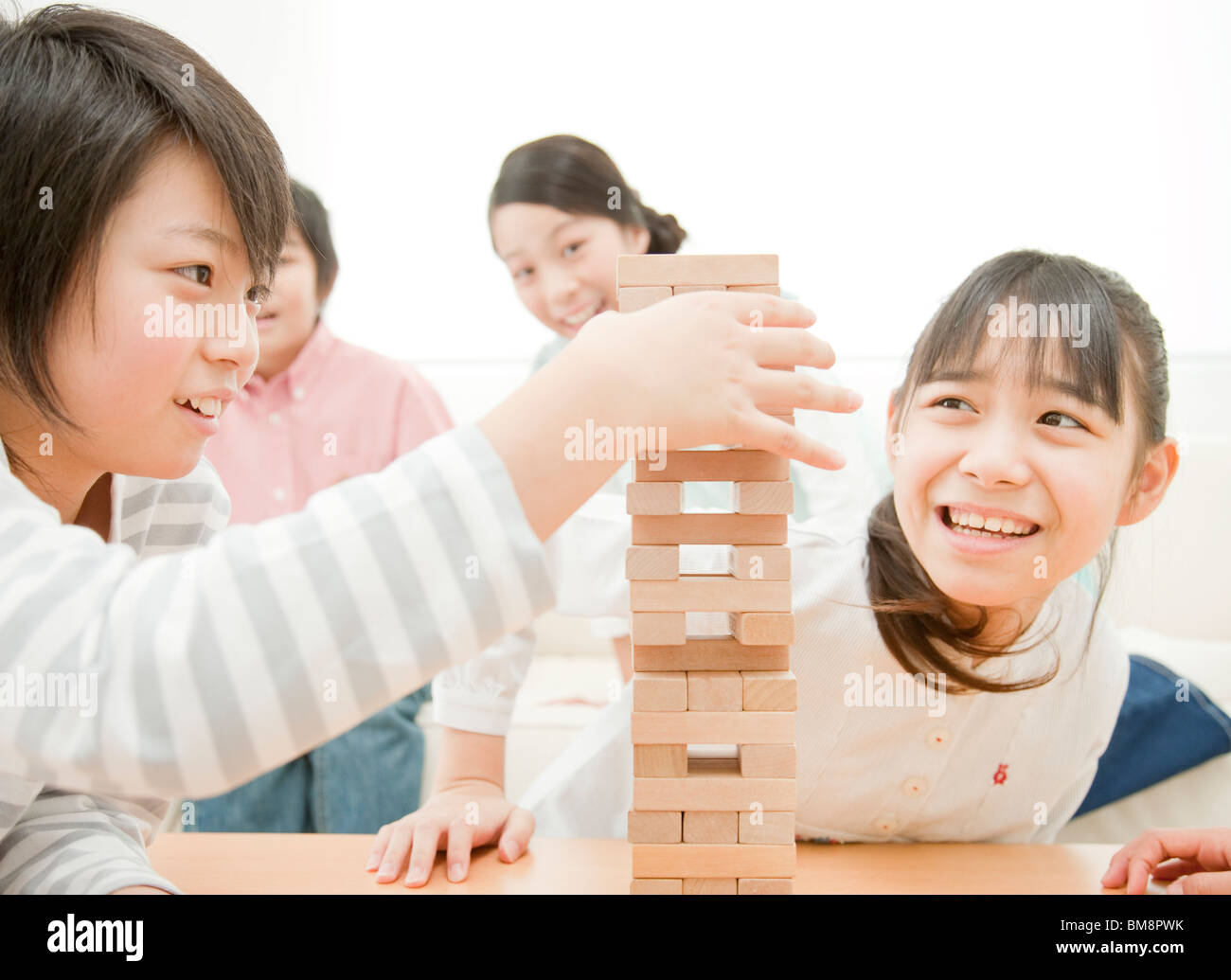 Friends playing Jenga Stock Photo - Alamy
