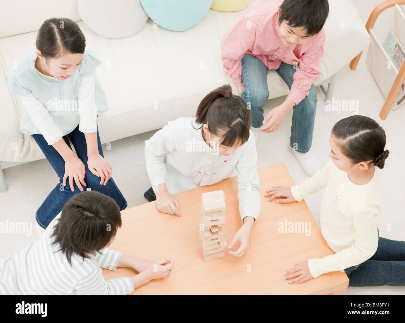 Friends playing Jenga, high angle view Stock Photo - Alamy