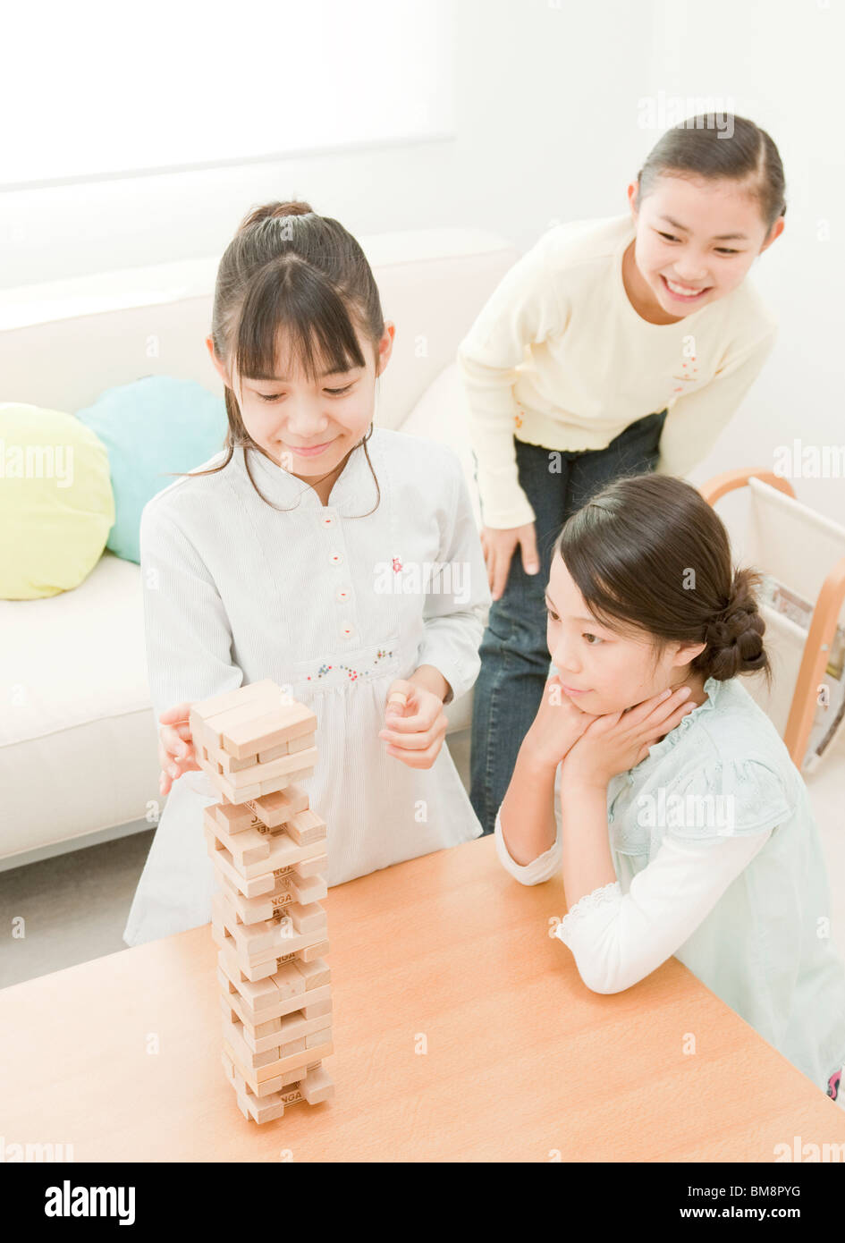 Three Girls Playing With Building Blocks Stock Photo - Alamy