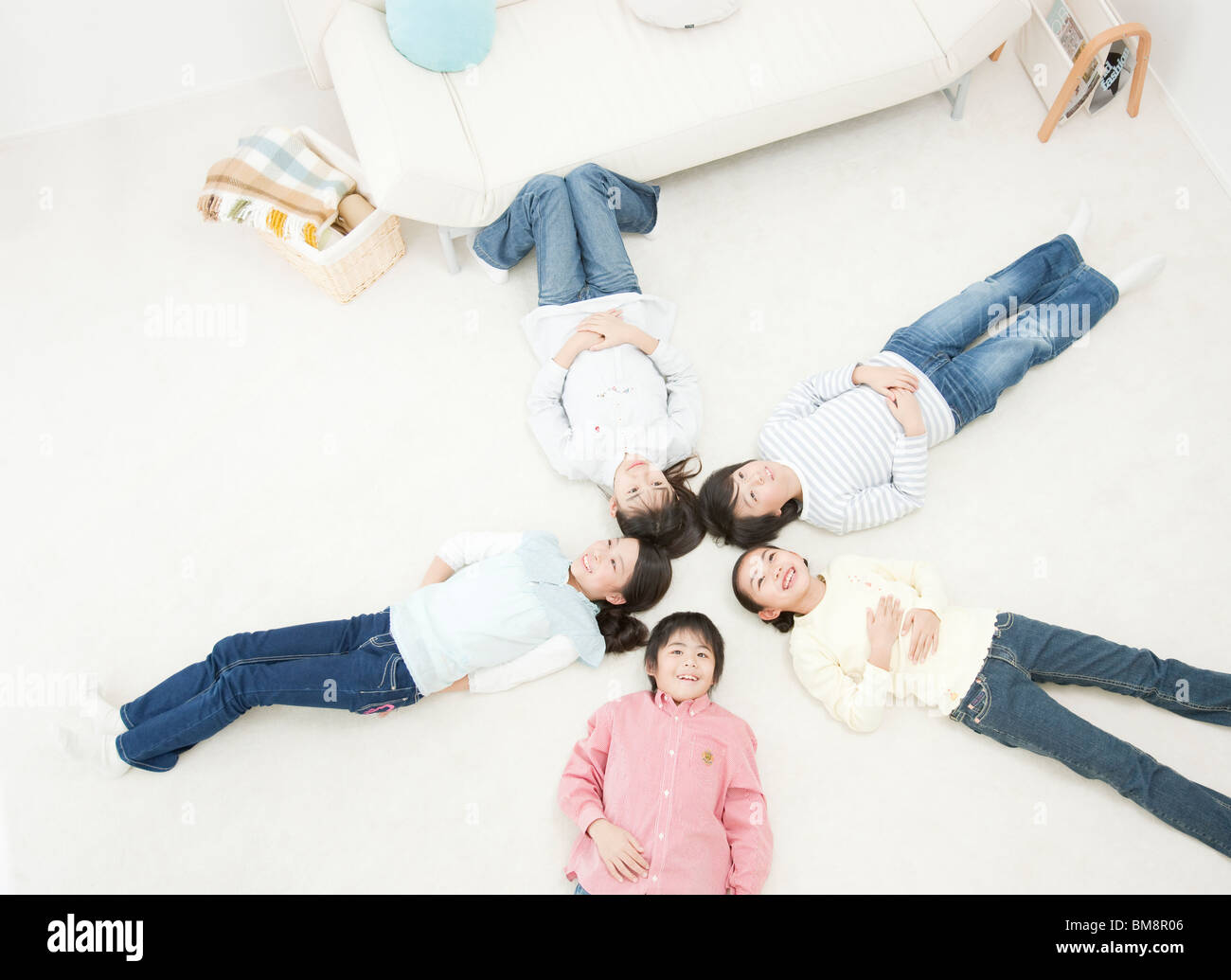 Children Laying Back on Floor Stock Photo - Alamy