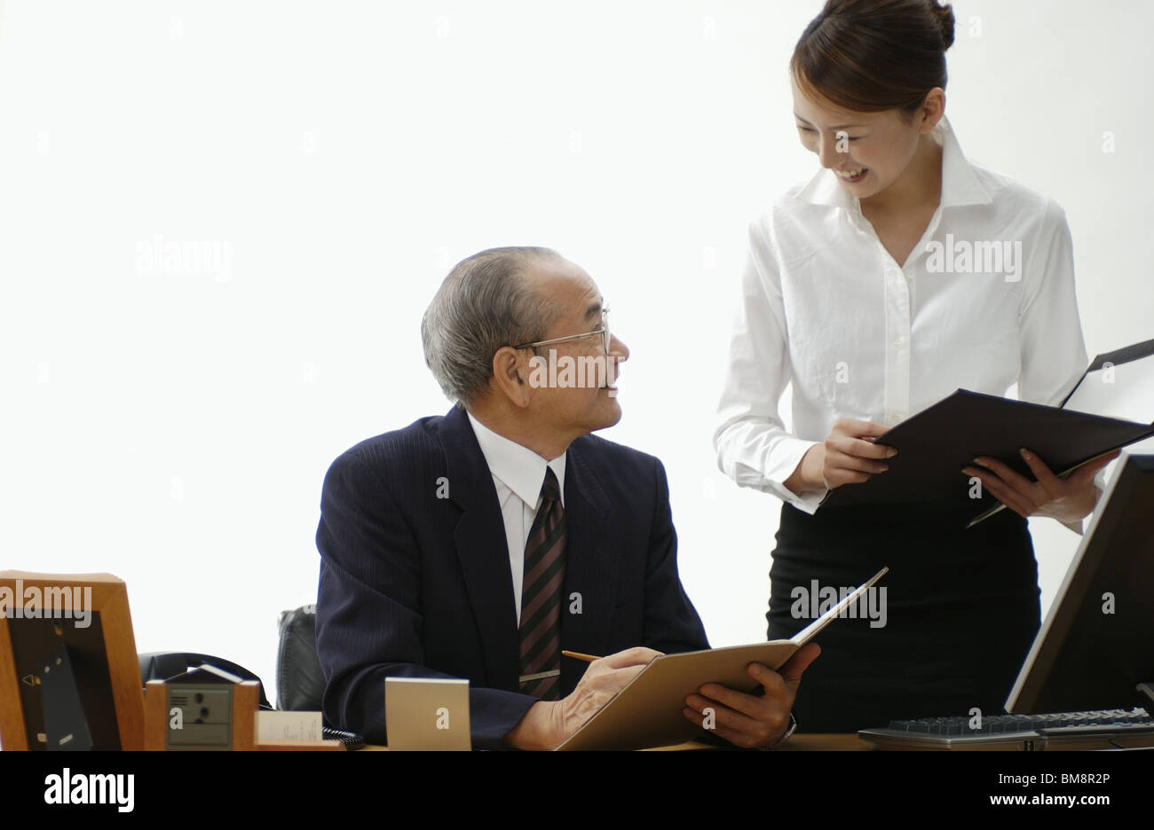 Young Woman Executive Assistant and Her Boss at Office Stock Photo - Alamy