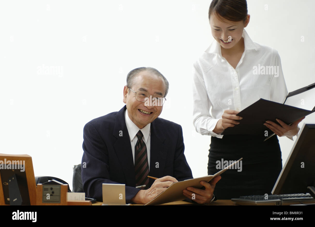 Young Woman Executive Assistant and Her Boss at Office Stock Photo - Alamy