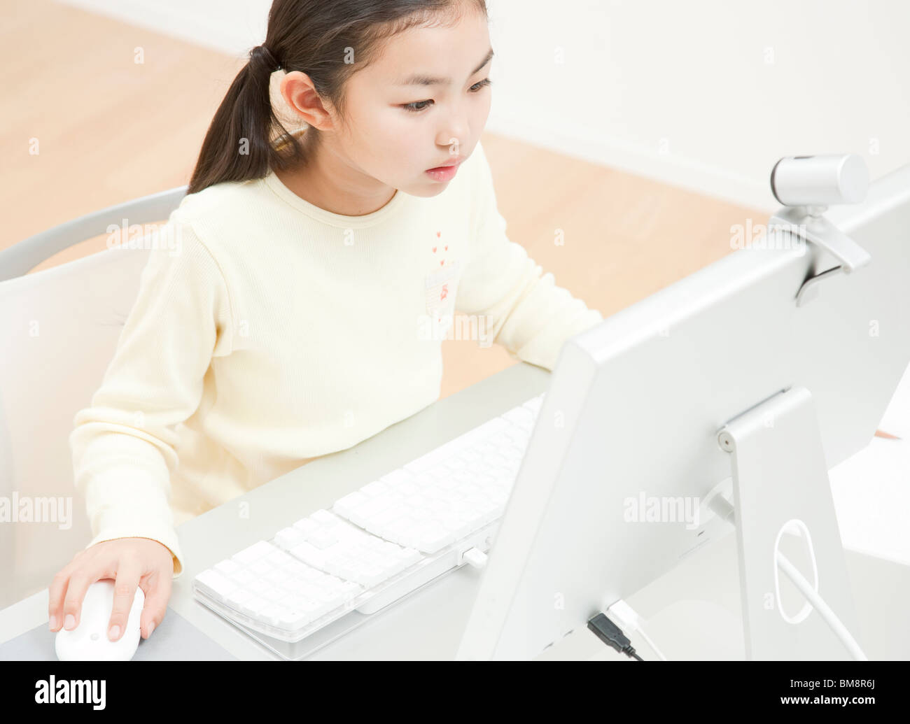A Girl Sitting at Desk, Desktop Computer on the Desk Stock Photo - Alamy
