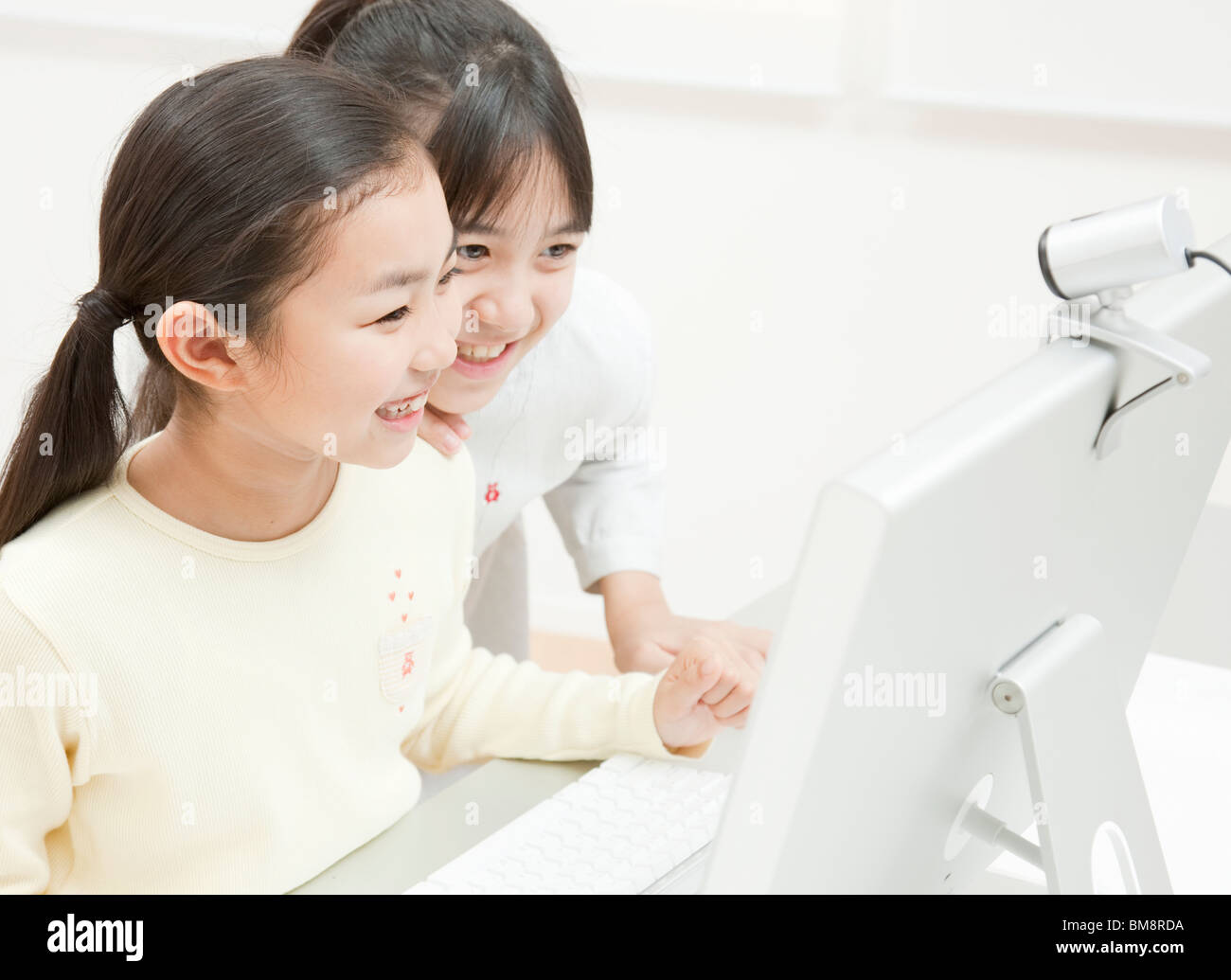 Girls Looking at Computer Display Stock Photo - Alamy
