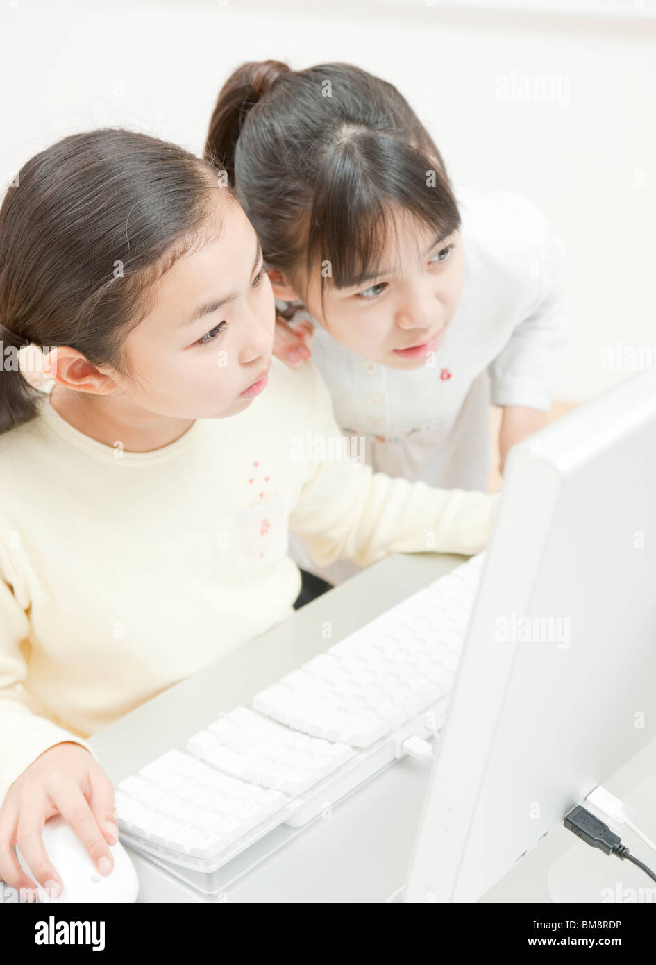 Girls Looking at Computer Display Stock Photo - Alamy
