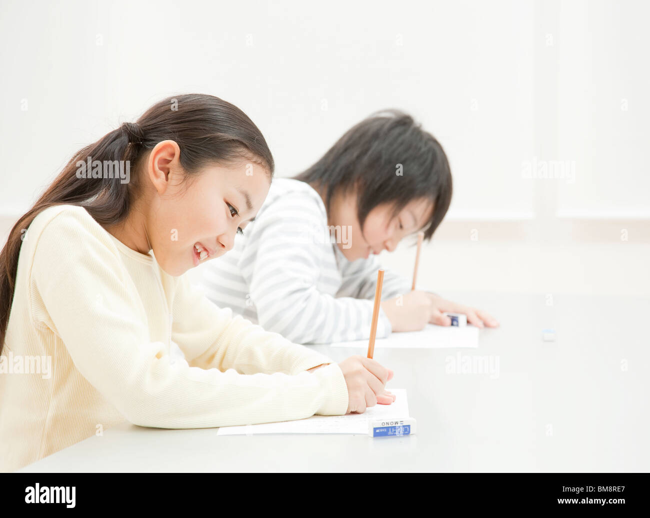 Children Studying at Desk Stock Photo - Alamy