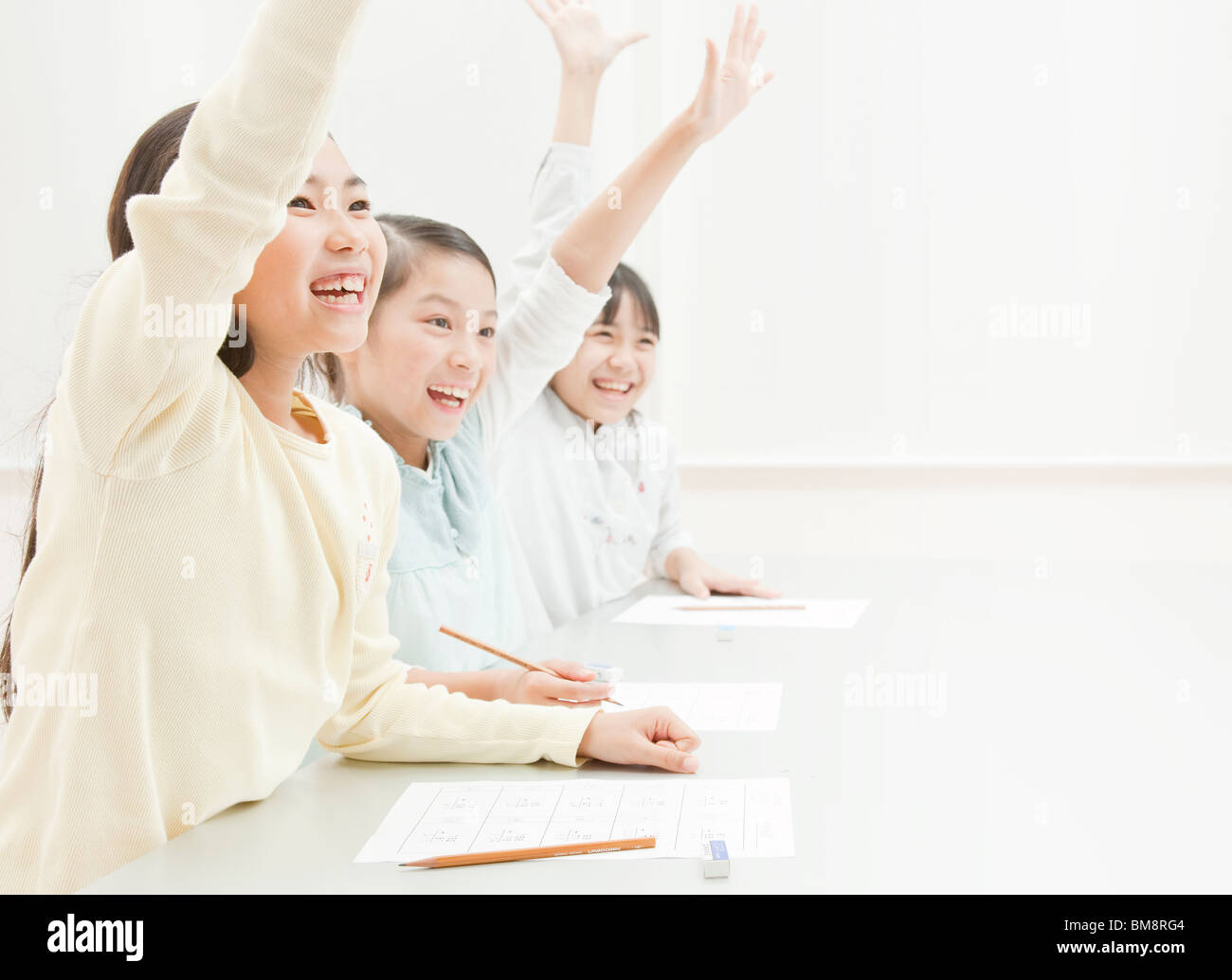 Children putting hands up hi-res stock photography and images - Alamy