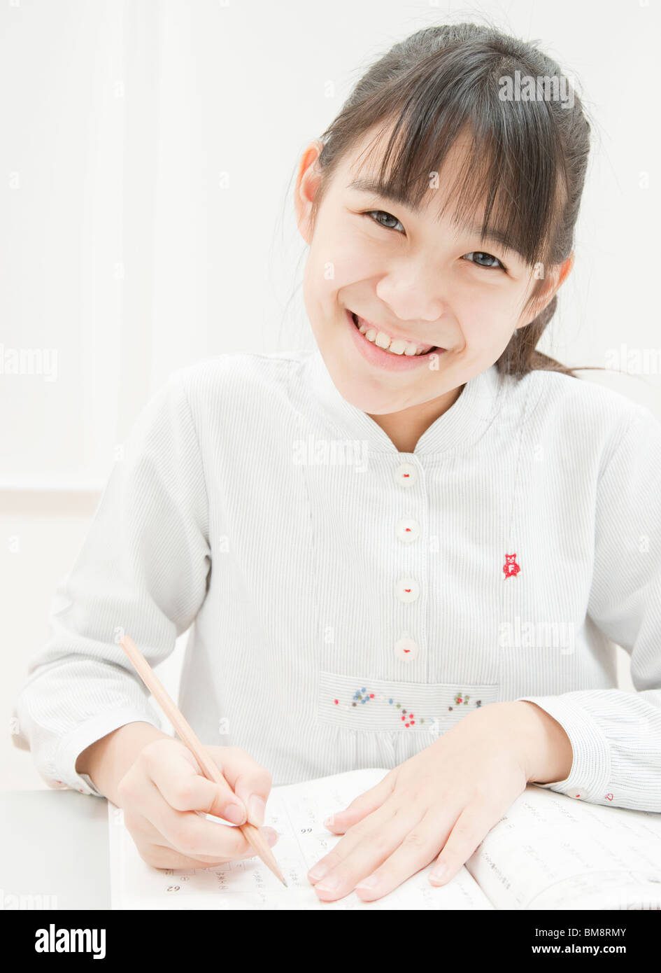 A Girl Studying at Desk Stock Photo - Alamy