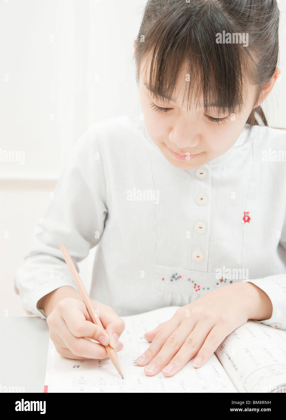 A Girl Studying at Desk Stock Photo - Alamy