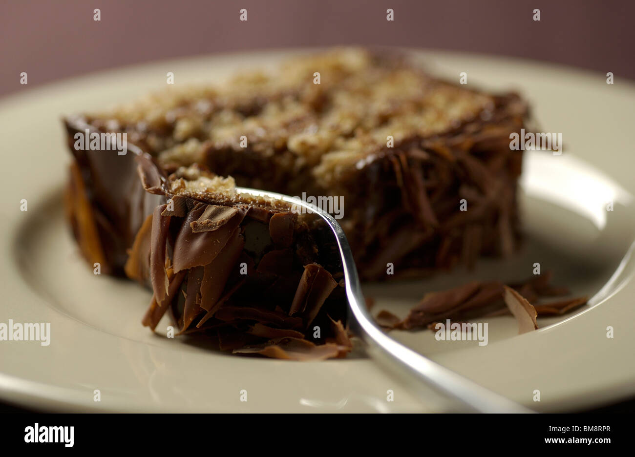 Fork on sliced chocolate cake, close up Stock Photo - Alamy