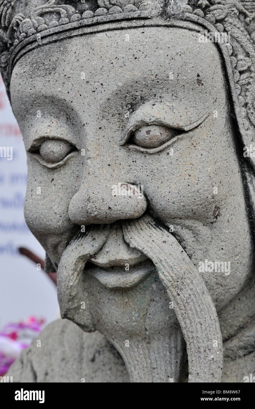 Close up of a stone guard statue in Wat Pho temple, Bangkok, Thailand ...