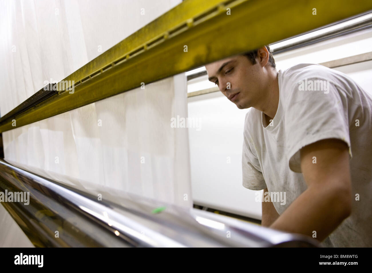 Fabric coating plant, machinist working on production line Stock Photo ...
