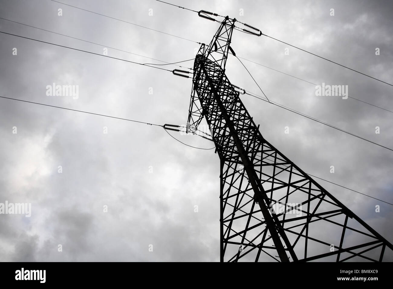 Electricity pylon against dramatic overcast sky Stock Photo - Alamy