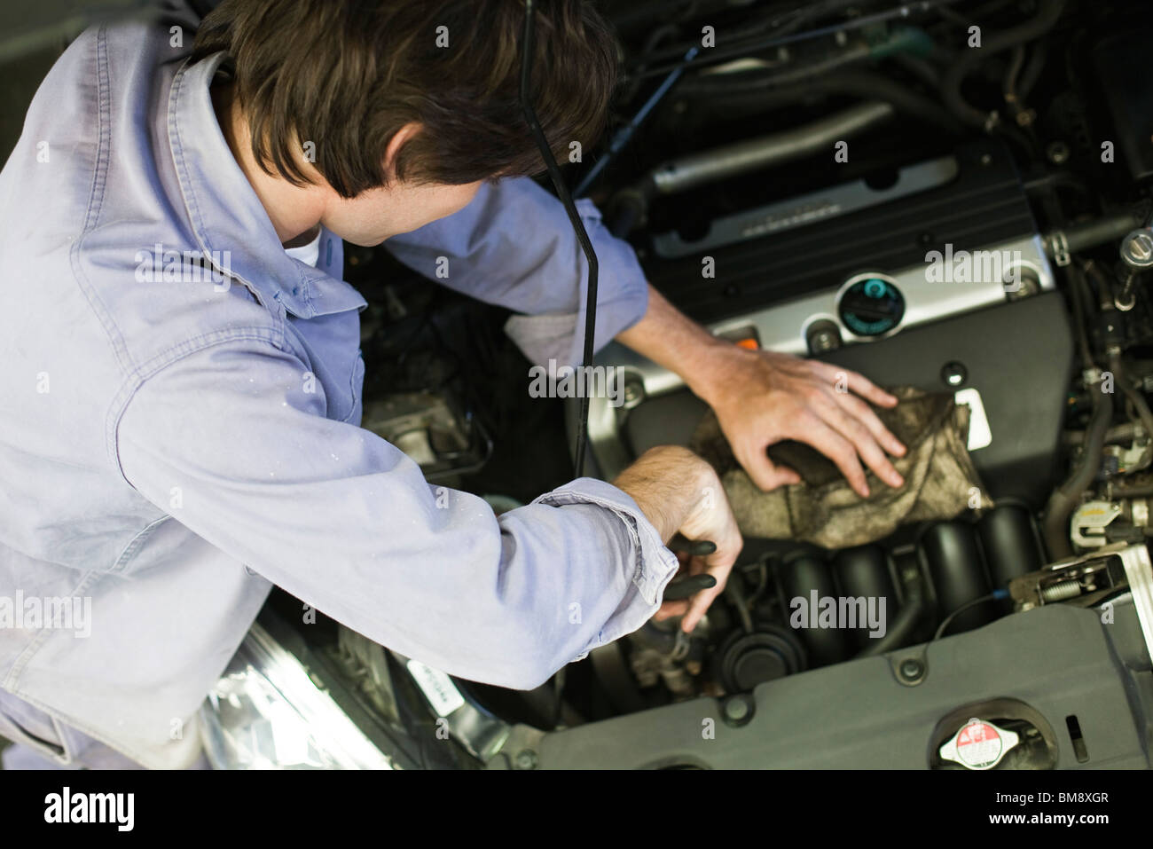 Mechanic repairing car engine Stock Photo - Alamy
