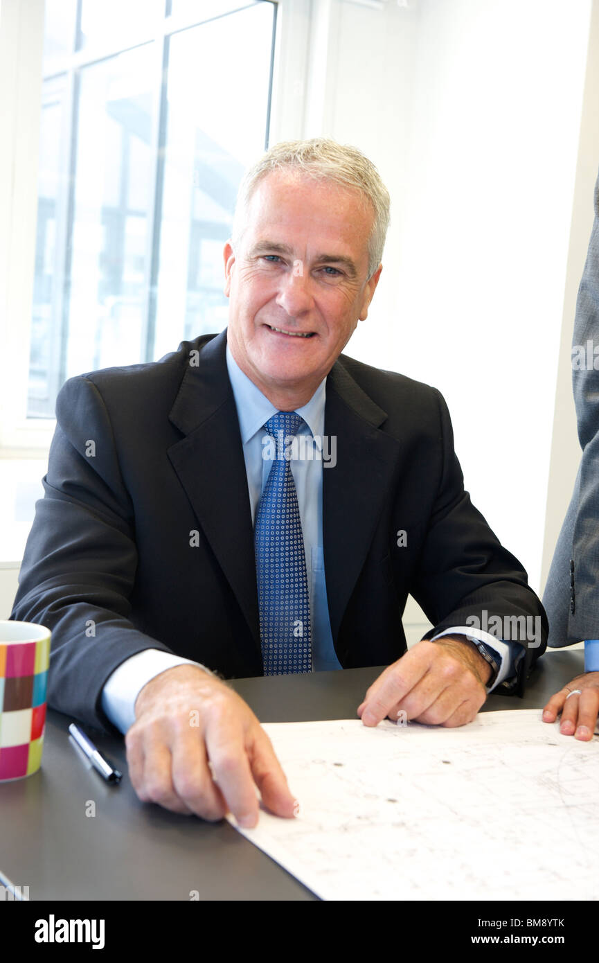 Businessman at boardroom table Stock Photo - Alamy