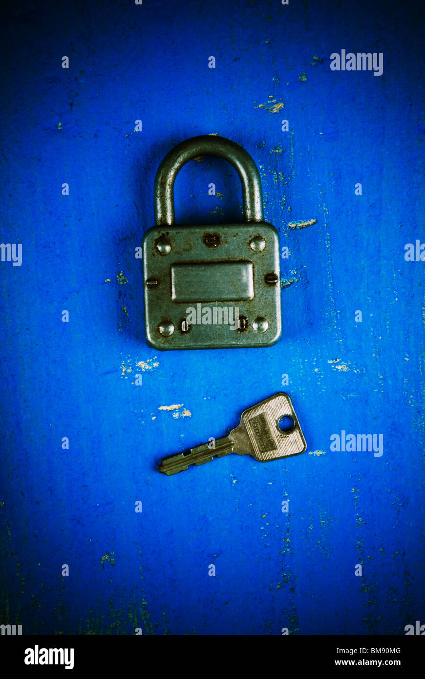 Old fashioned padlock with key on a blue wooden background Stock Photo ...
