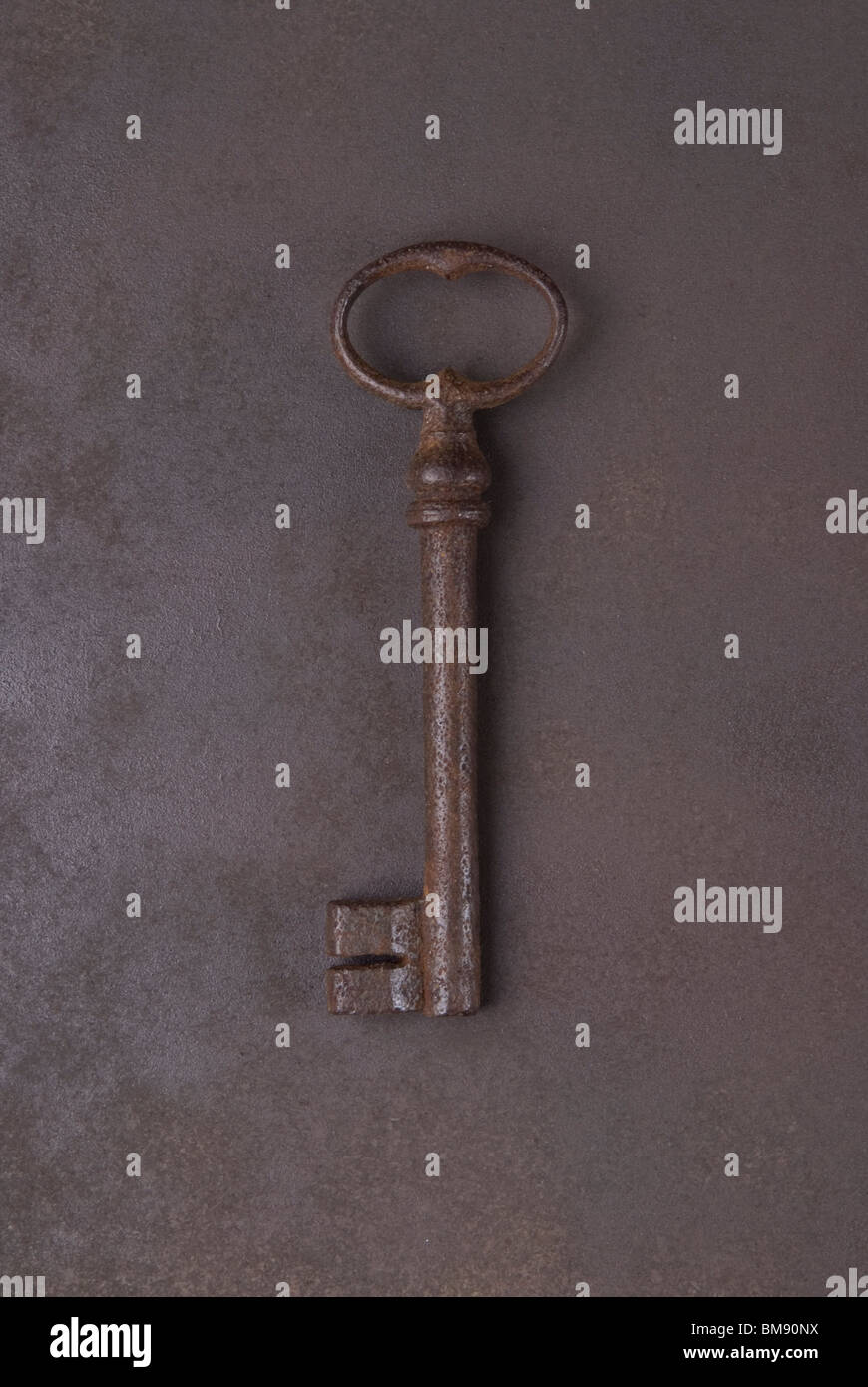 Old rusty house key over a metal background Stock Photo - Alamy