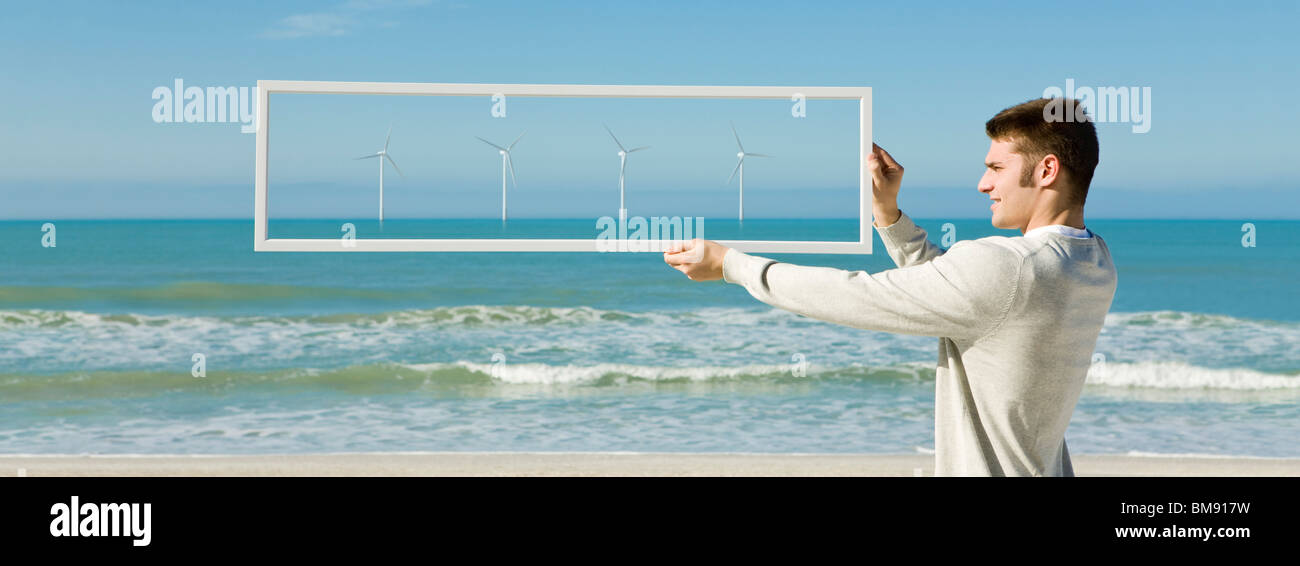 Offshore wind turbines on horizon viewed from beach Stock Photo - Alamy