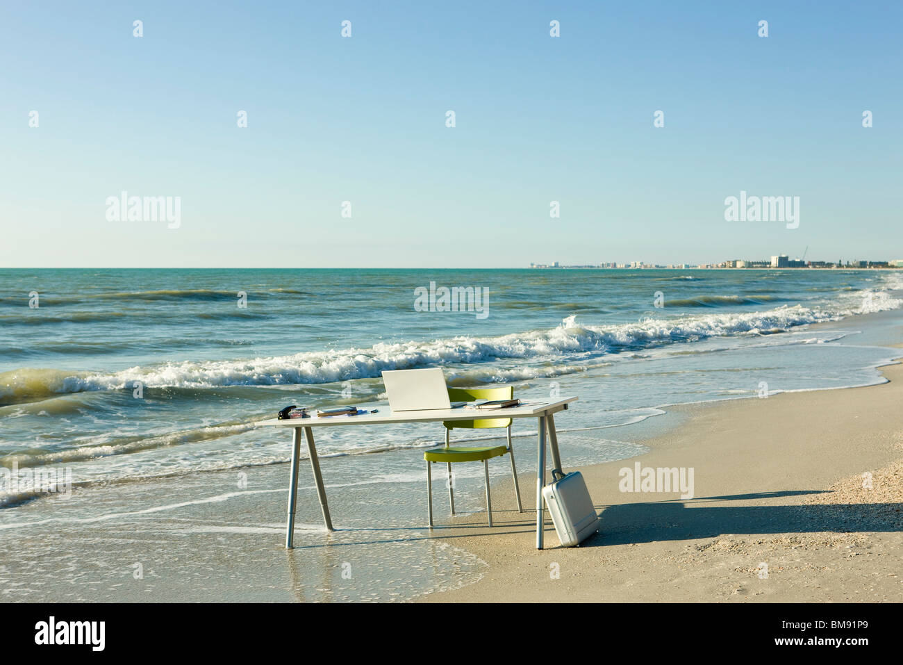 Desk and laptop computer on beach Stock Photo - Alamy