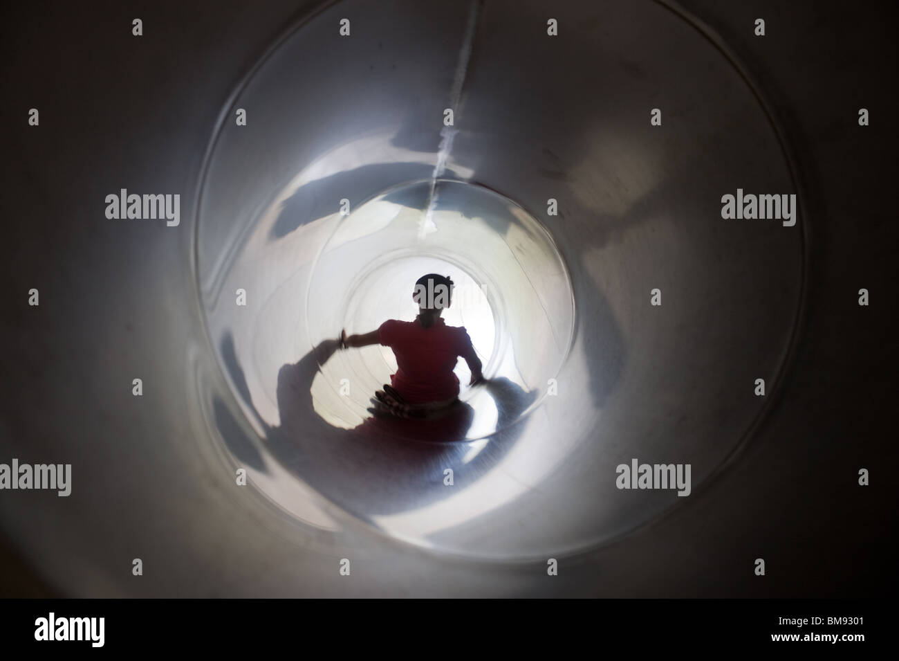 young child sliding down a tunnel slide in north yorkshire Stock Photo ...