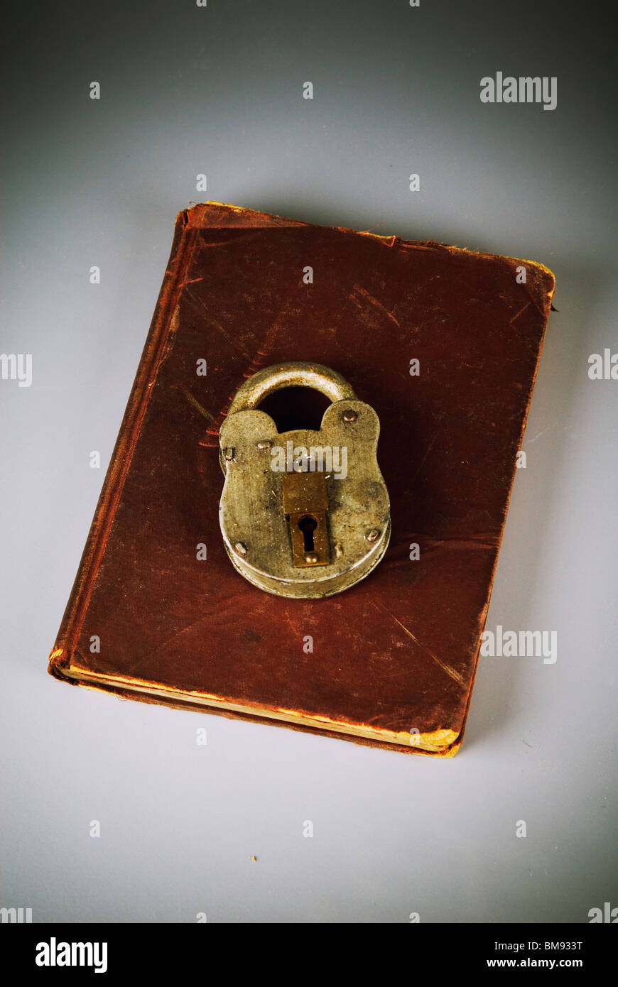 Old fashioned padlock over an old book Stock Photo - Alamy