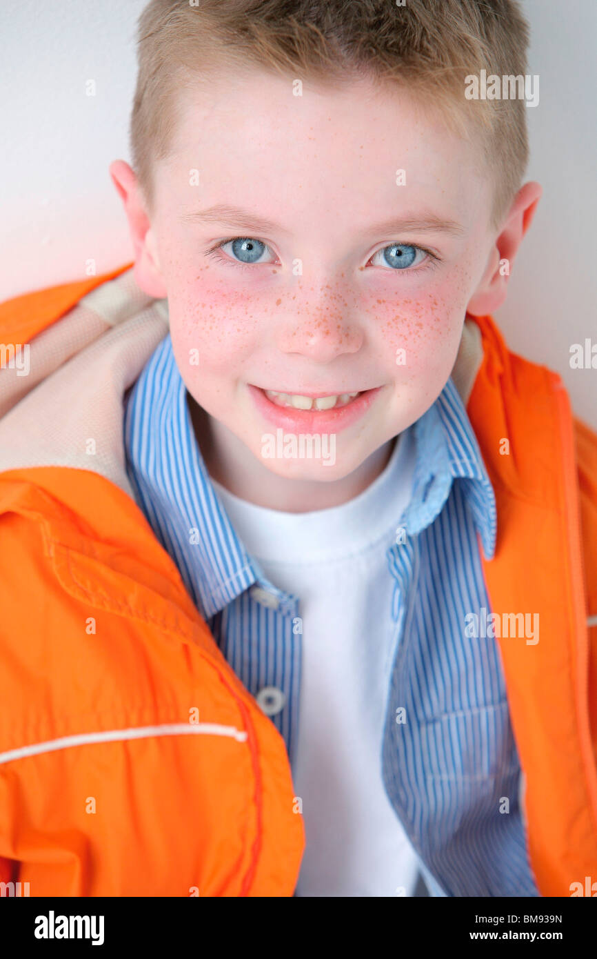 Young Boy With Freckles Smiling At Camera Stock Photo - Alamy