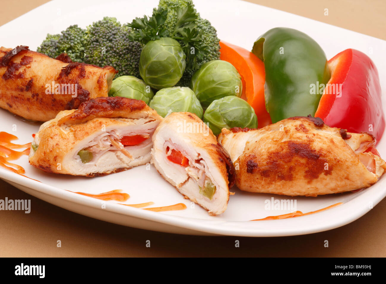 Chicken rolls and fresh vegetables on plate Stock Photo - Alamy