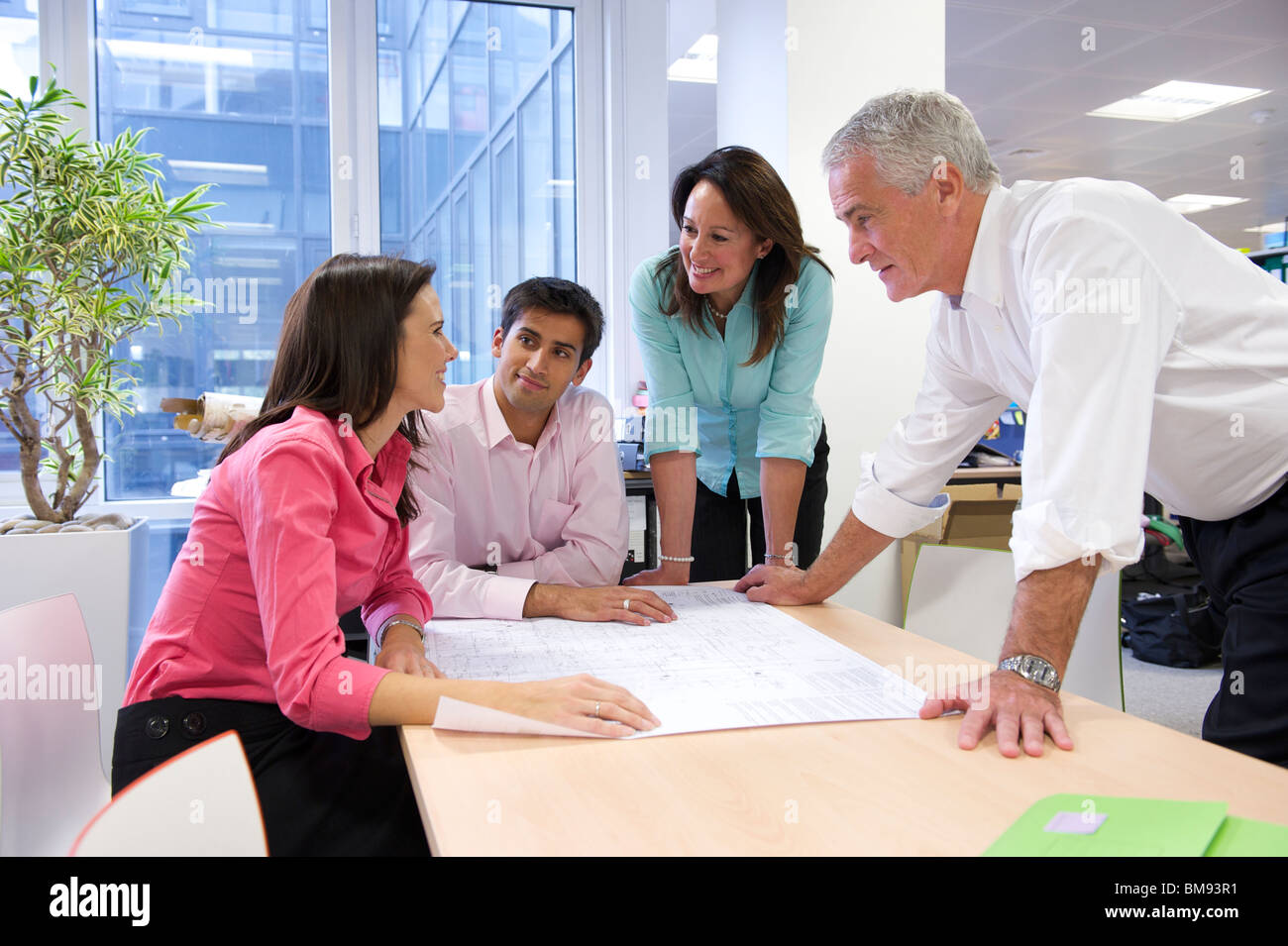 Team meeting to discuss plan drawings at architects office Stock Photo ...