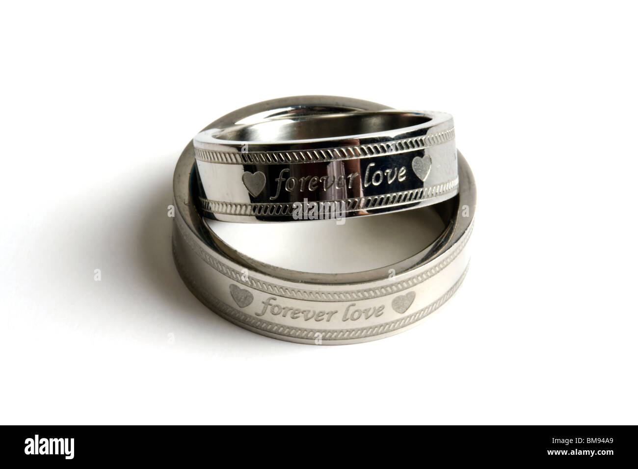Wedding rings of Forever Love isolated on white Stock Photo - Alamy